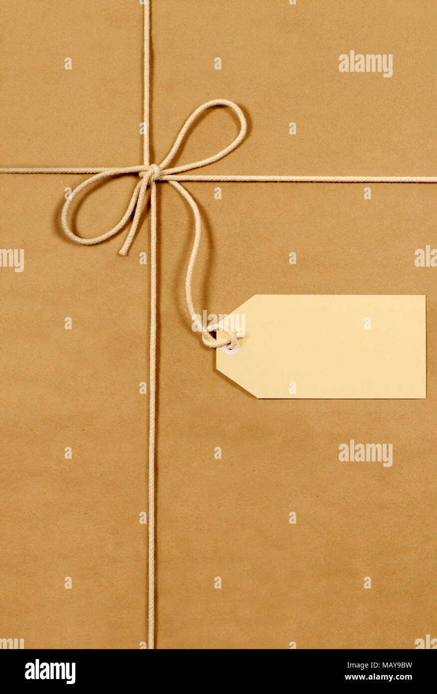 Brown paper parcel background with string and label Stock Photo - Alamy