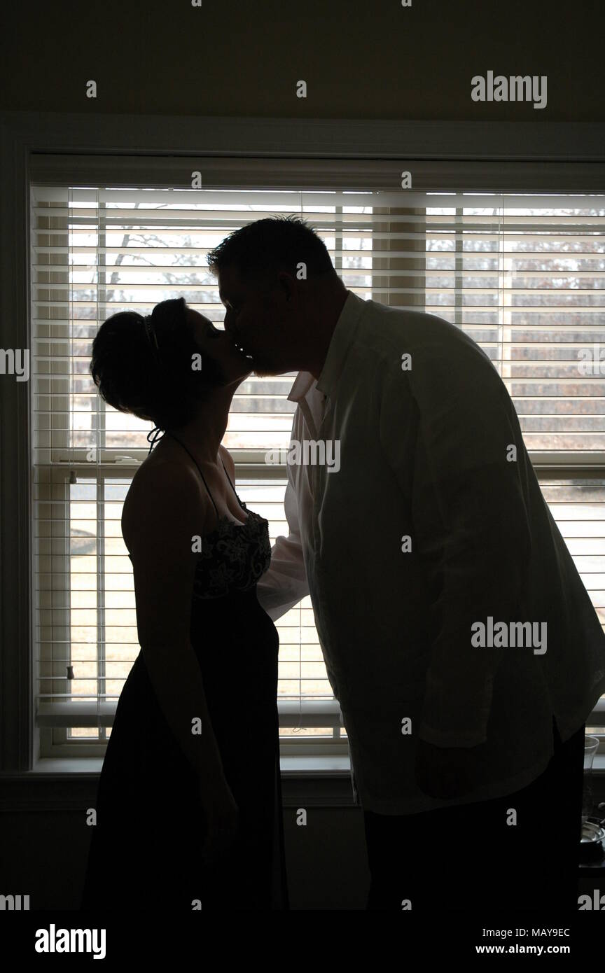 A couple kiss before a window on their wedding day Stock Photo - Alamy