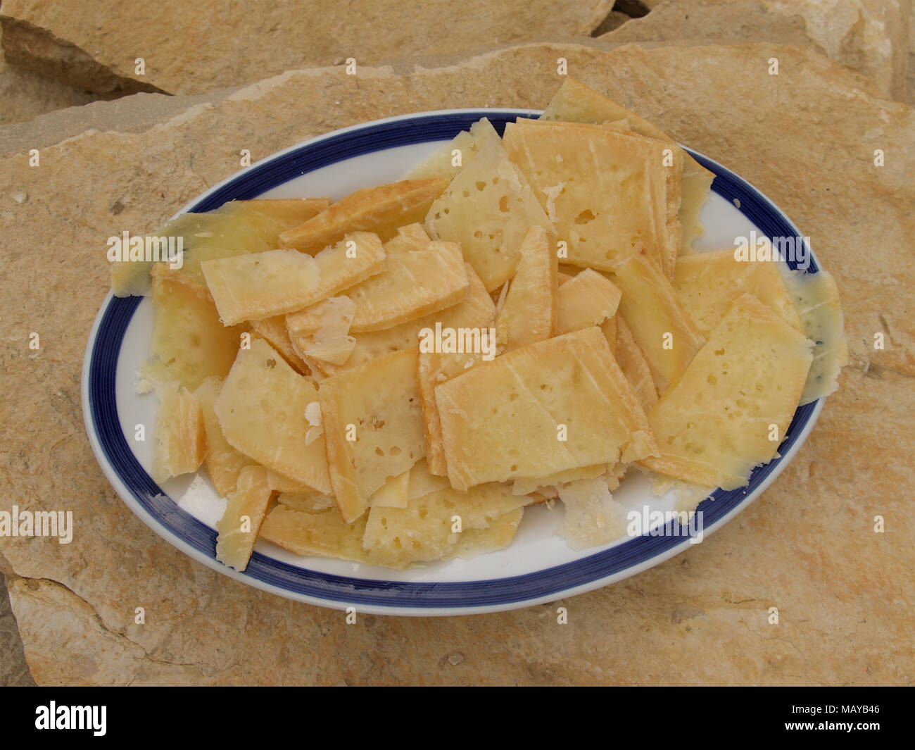 croatian cheese on the plate outdoor with stone background, sliced ...
