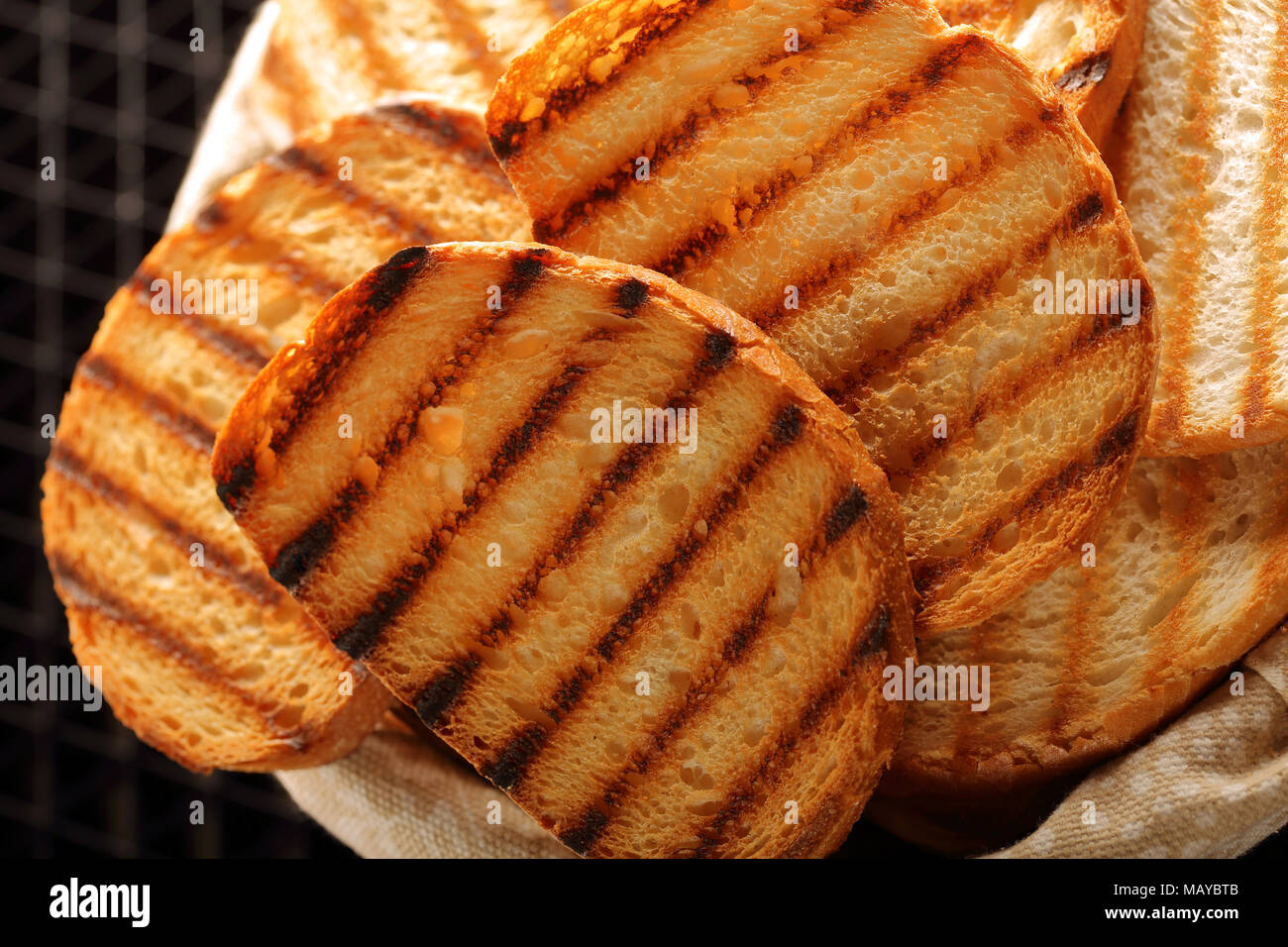 Fresh toast in basket on black background Stock Photo - Alamy