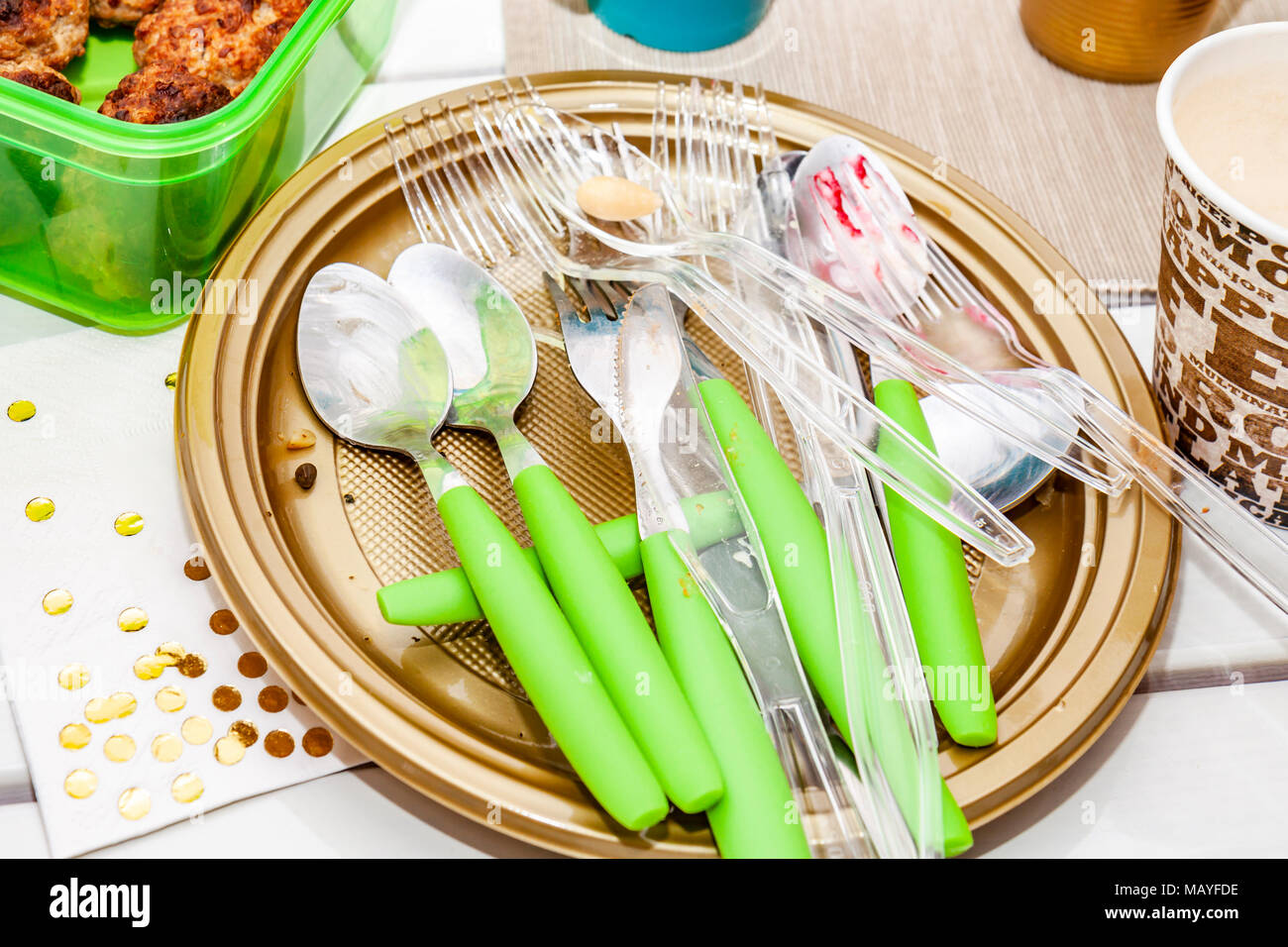 Used plate with salad and cutlery after the party Stock Photo - Alamy