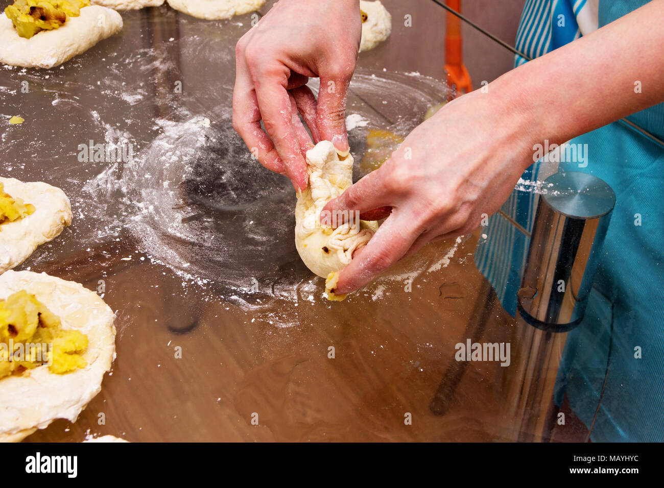 The woman in the kitchen completes the molding of the pie Stock Photo ...