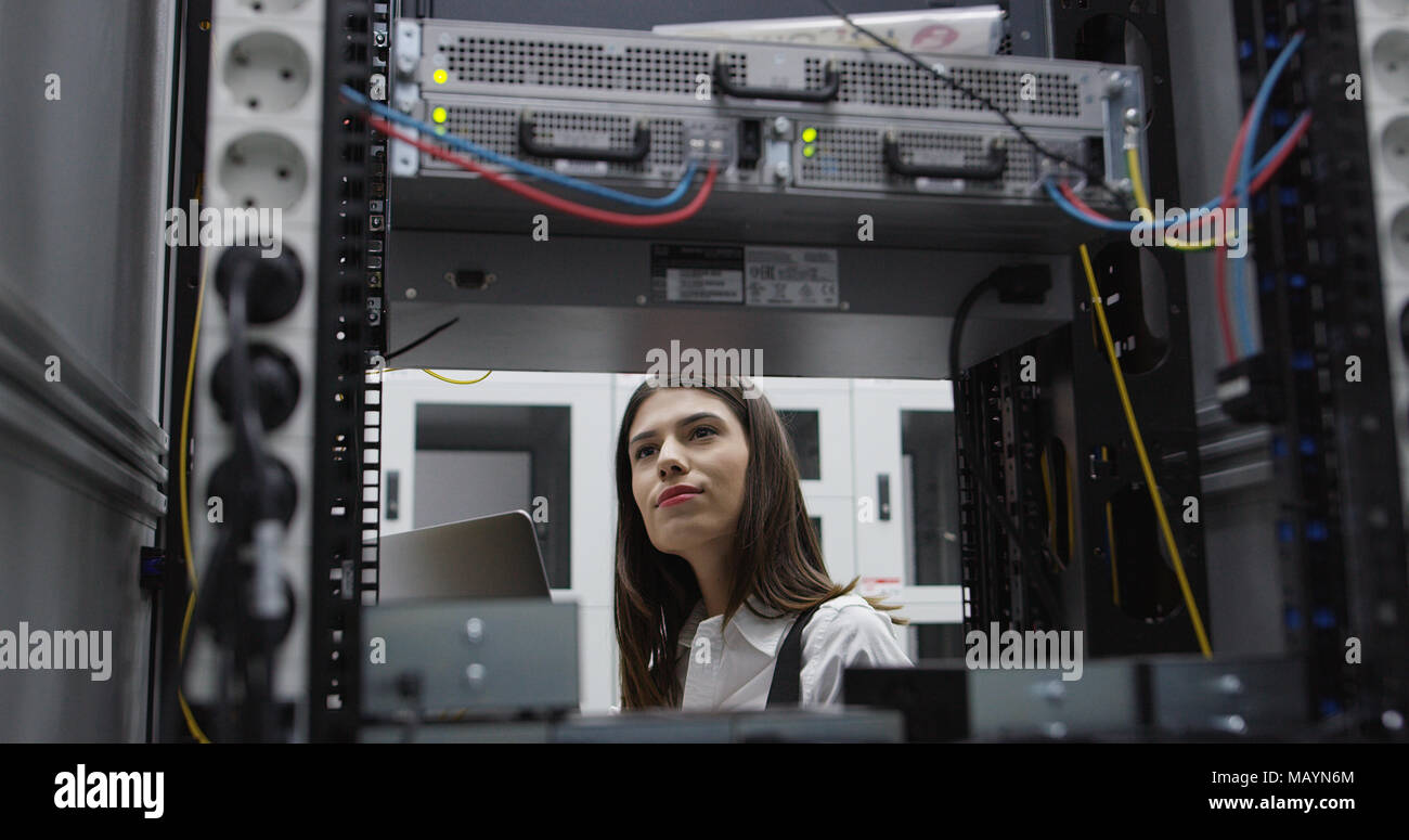 Technician performing maintenance tasks in a server room rack Stock ...