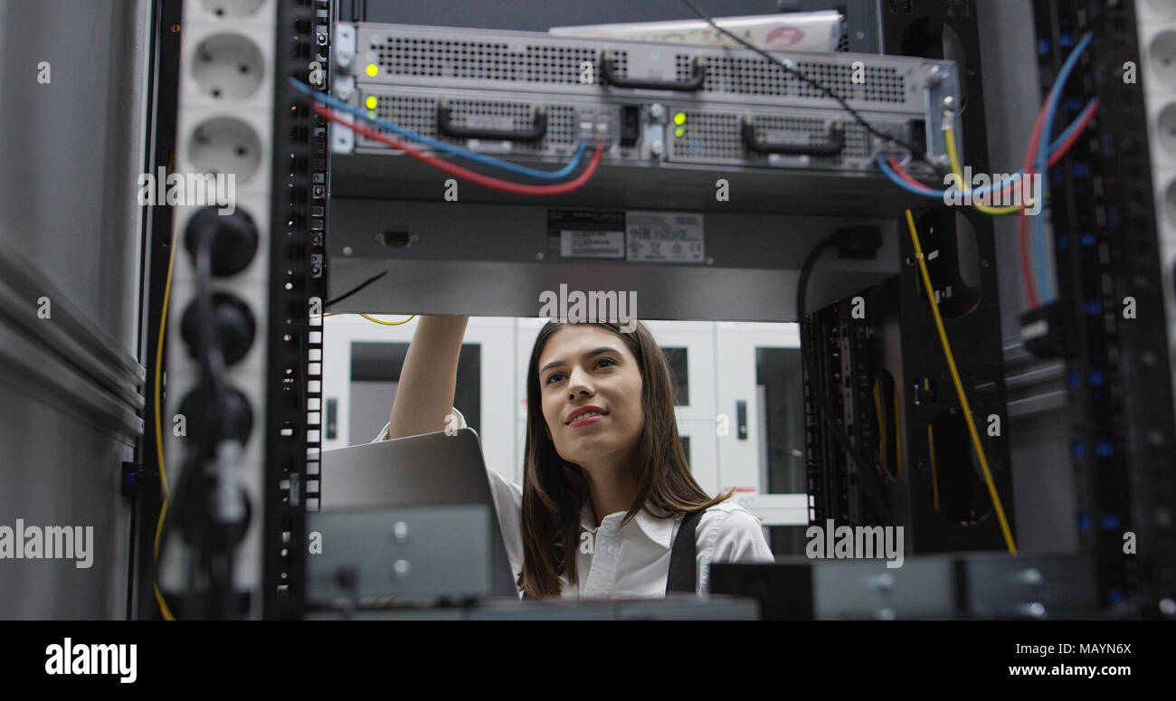 Technician performing maintenance tasks in a server room rack Stock ...