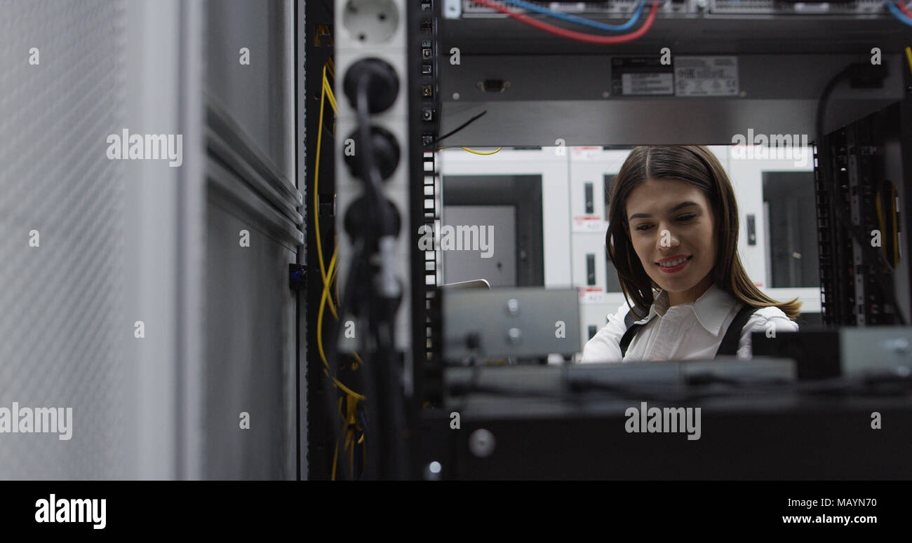 Technician performing maintenance tasks in a server room rack Stock ...