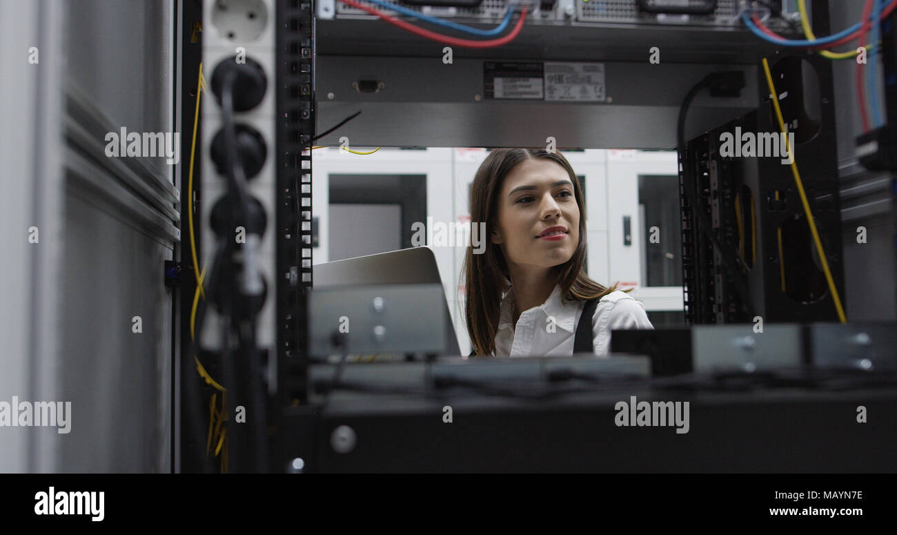 Technician performing maintenance tasks in a server room rack Stock ...