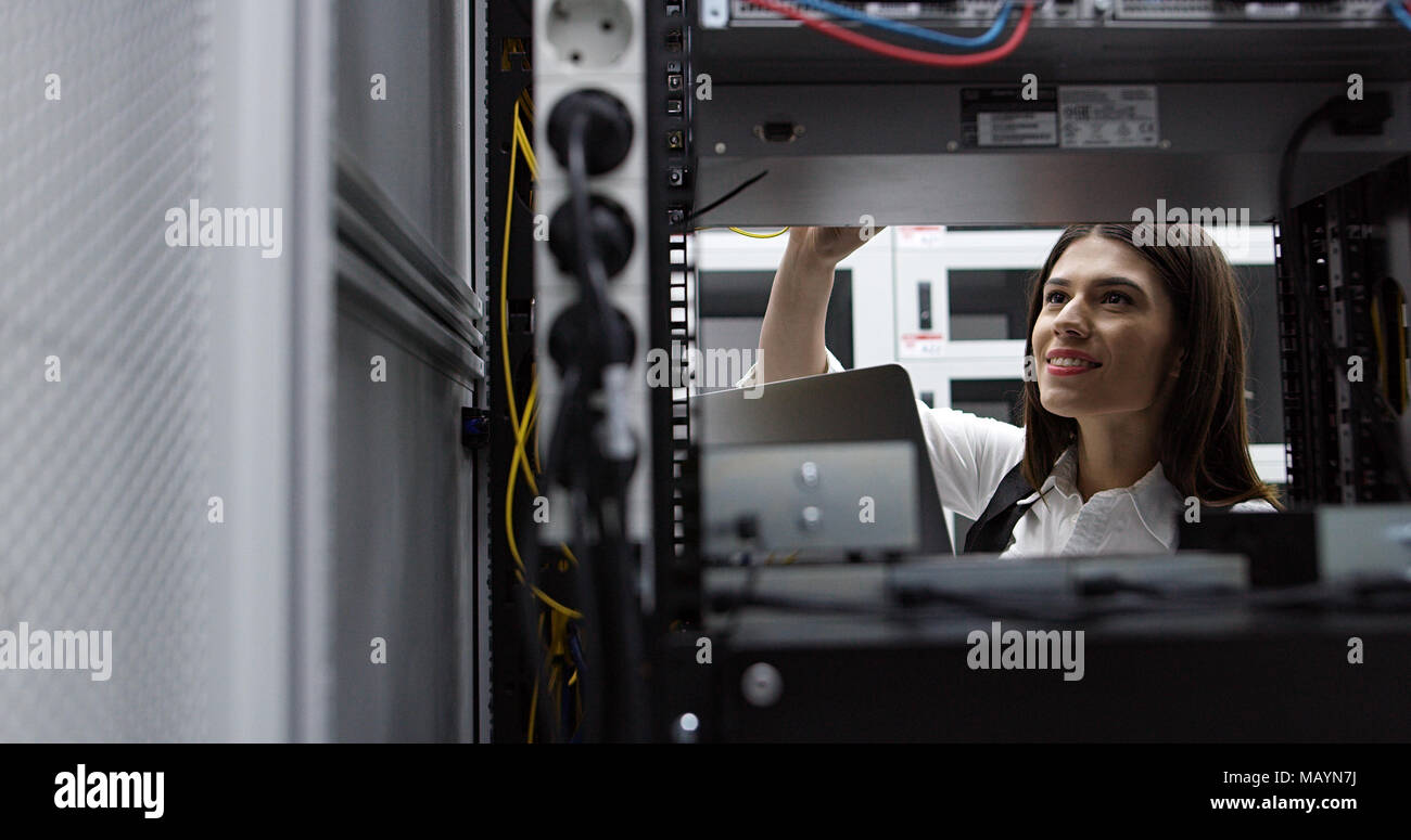 Technician performing maintenance tasks in a server room rack Stock ...
