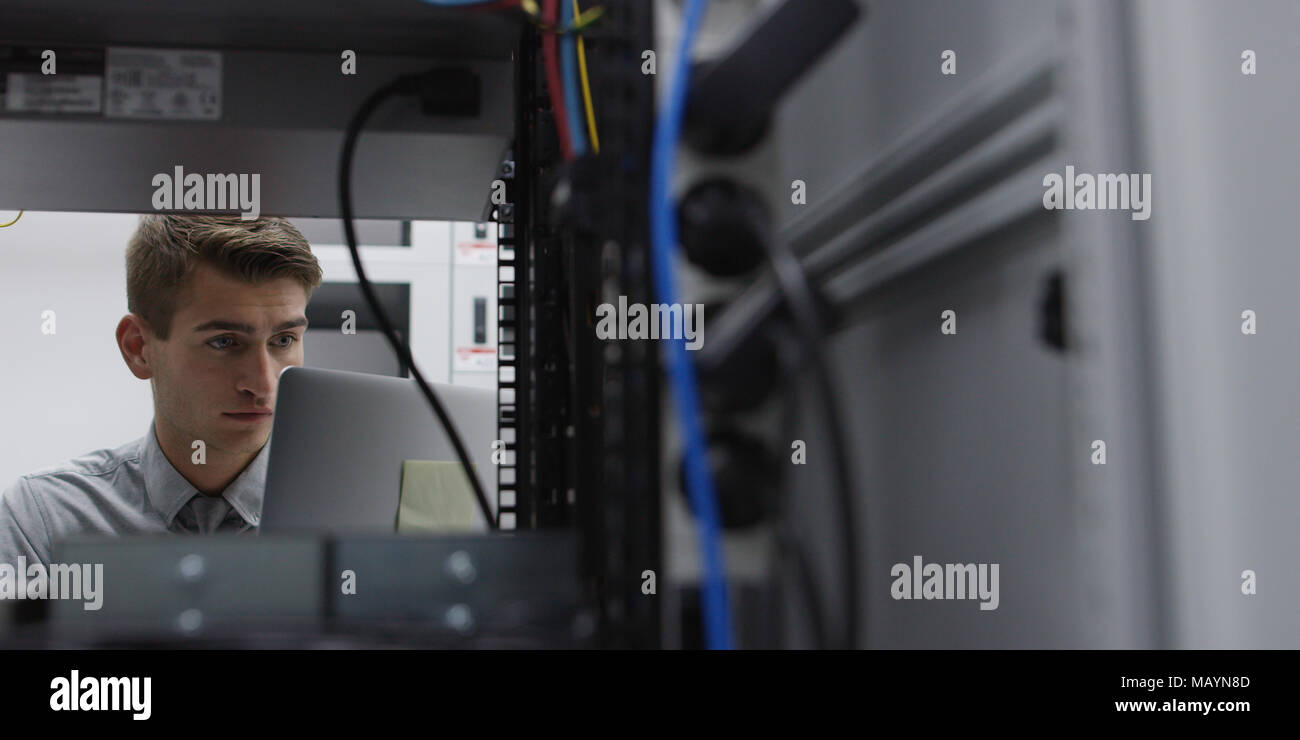 Technician performing maintenance tasks in a server room rack Stock ...