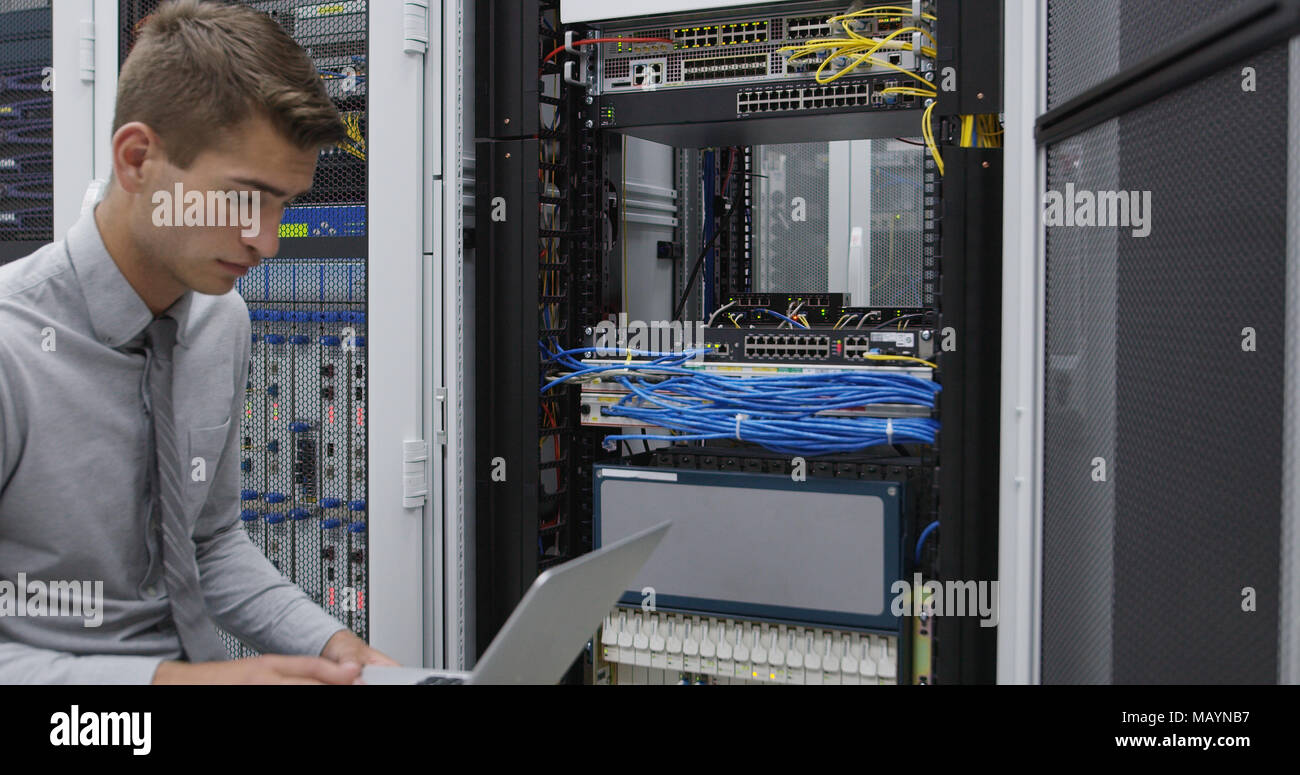Technician performing maintenance tasks in a server room rack Stock ...