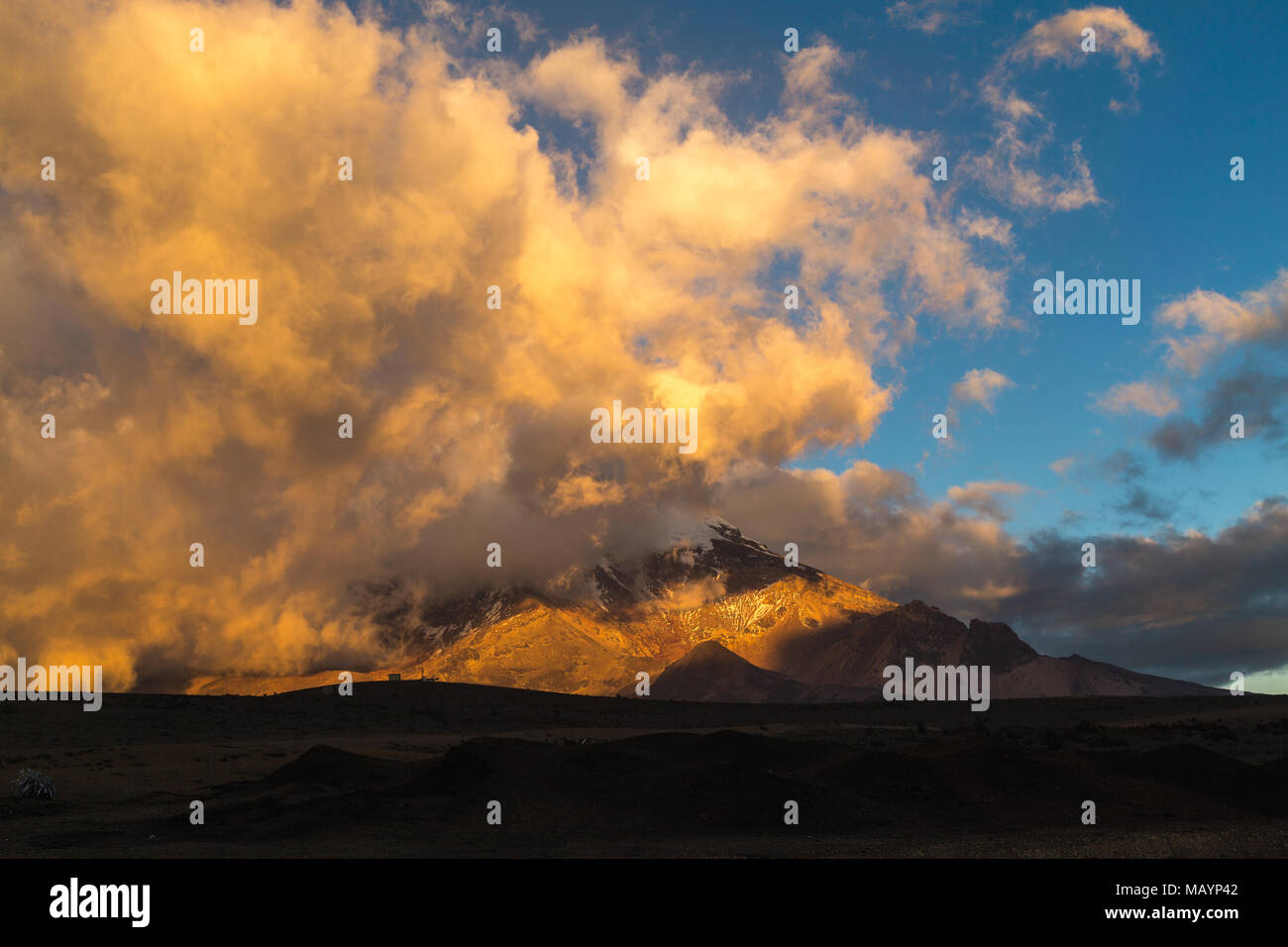Golden clouds in frantic chaos on the Chimborazo volcano Stock Photo ...