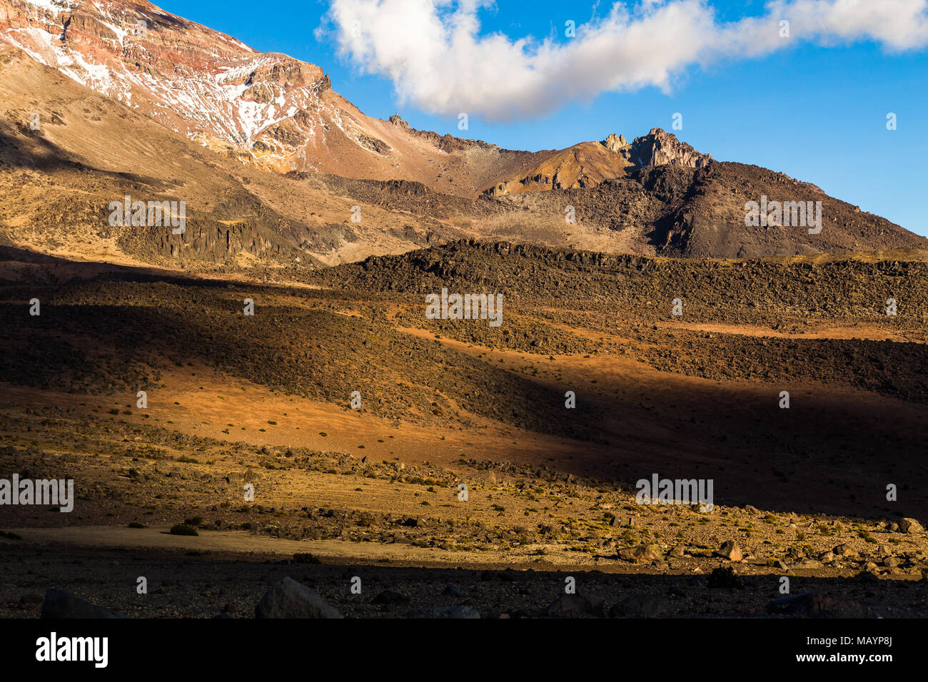 Rocky and desert slopes at sunset on the slopes of Chimborazo volcano ...