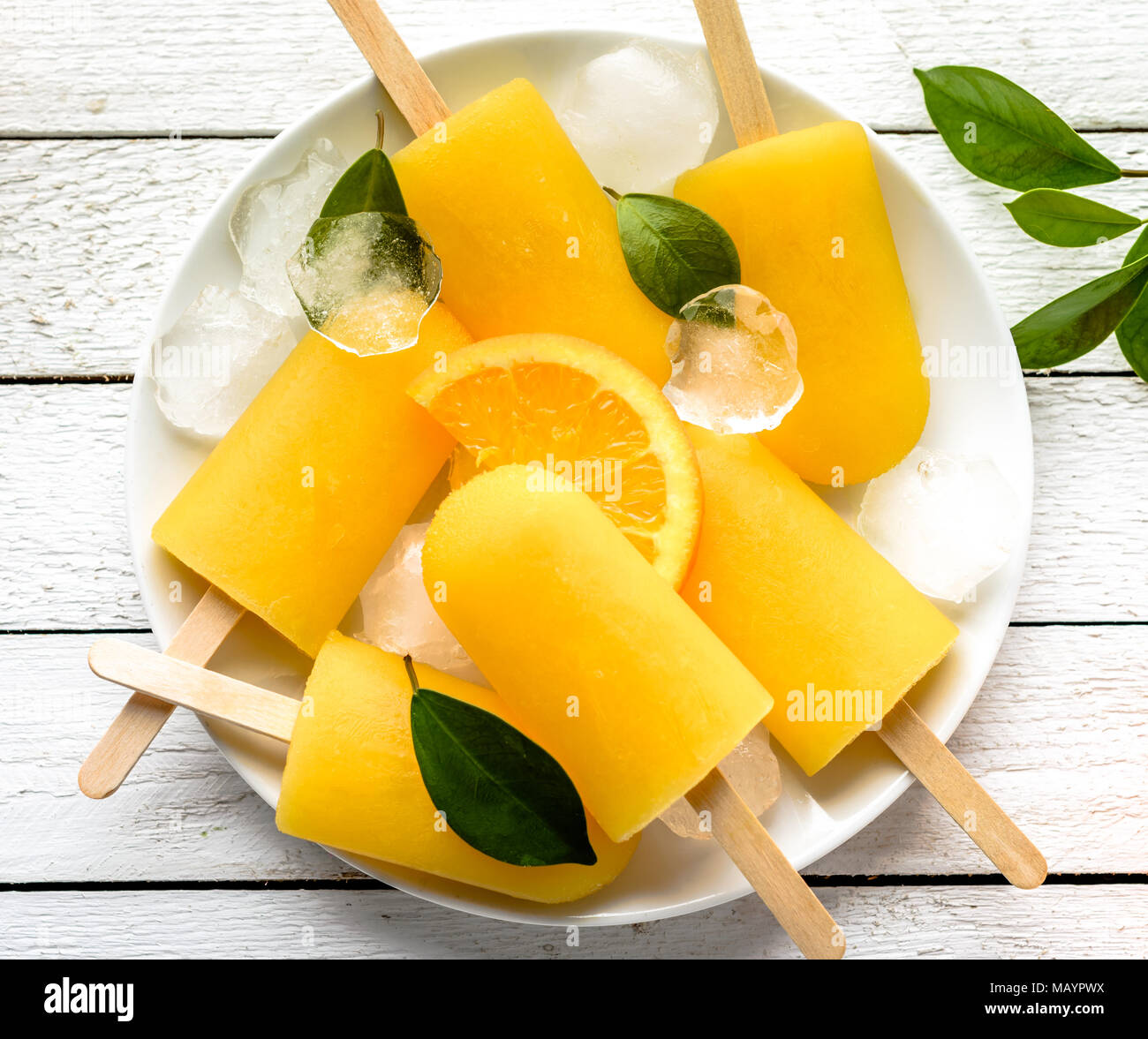 Orange popsicles on white wooden background. Homemade ice pops, top ...