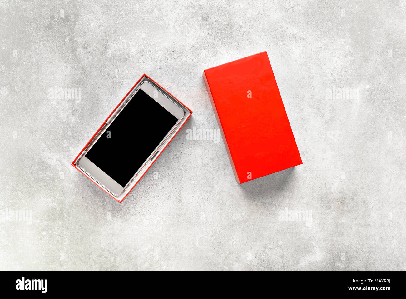 New cell phone and box, smartphone with black screen and blank space ...