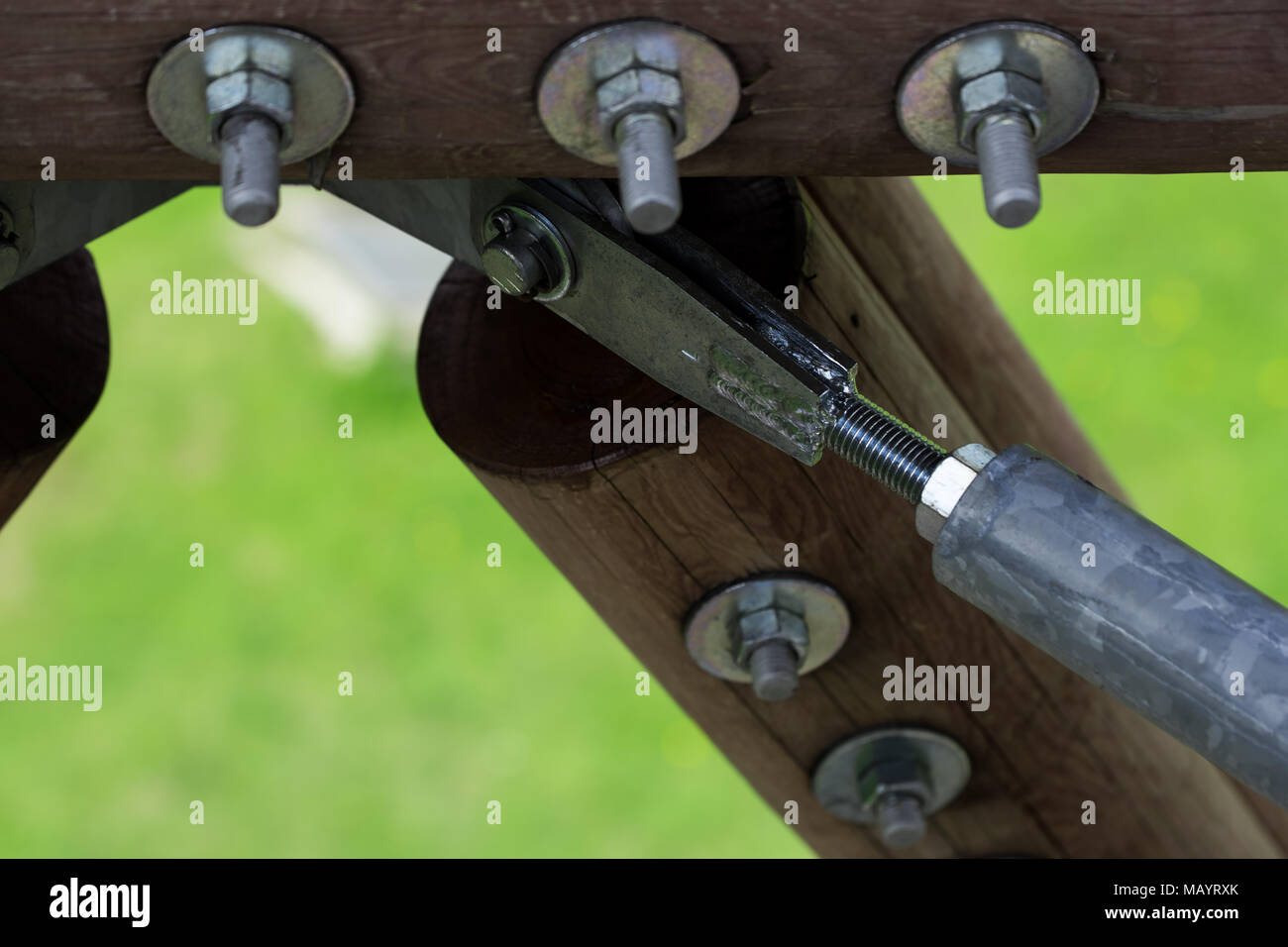 Wood beams professionally connected by metal screw and nut with ...