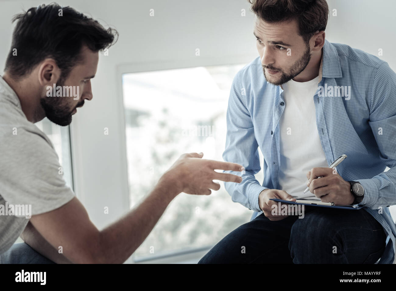 Pleasant young man taking notes Stock Photo - Alamy