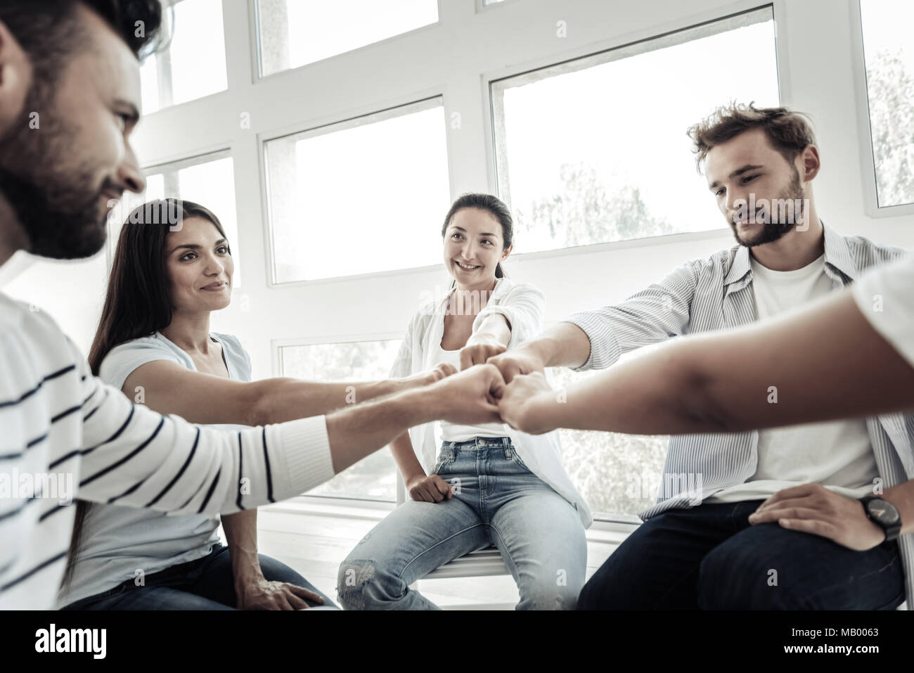 Positive cheerful people showing their unity Stock Photo - Alamy