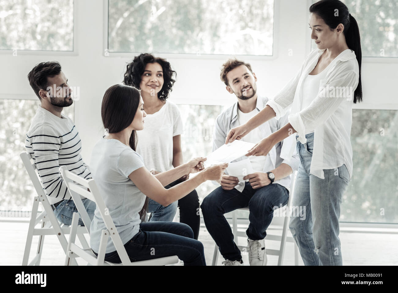 Smart young woman taking a sheet of paper Stock Photo - Alamy