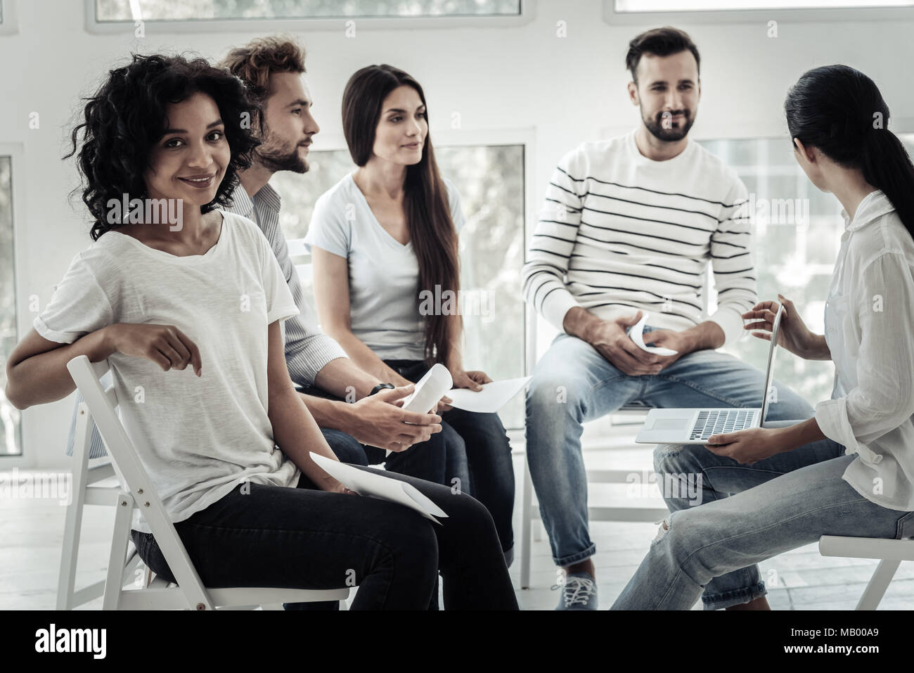 Happy young woman taking part in group activities Stock Photo - Alamy