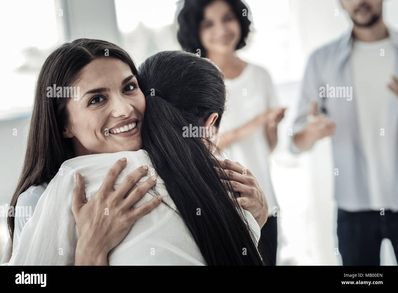 Happy cheerful woman being hugged Stock Photo - Alamy