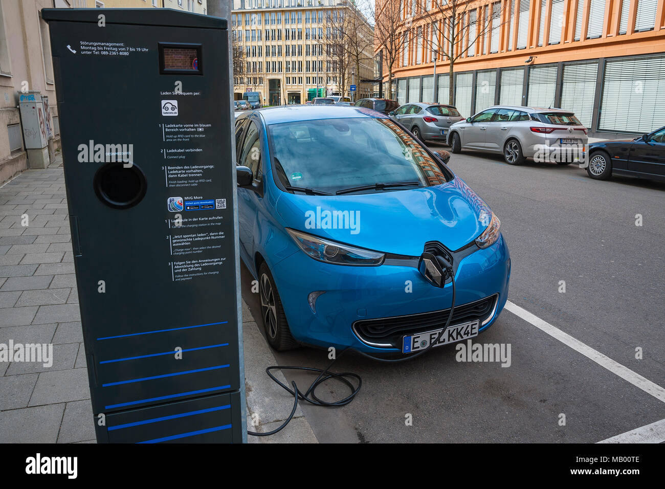 Electric car is charged at green electricity charging station with ...