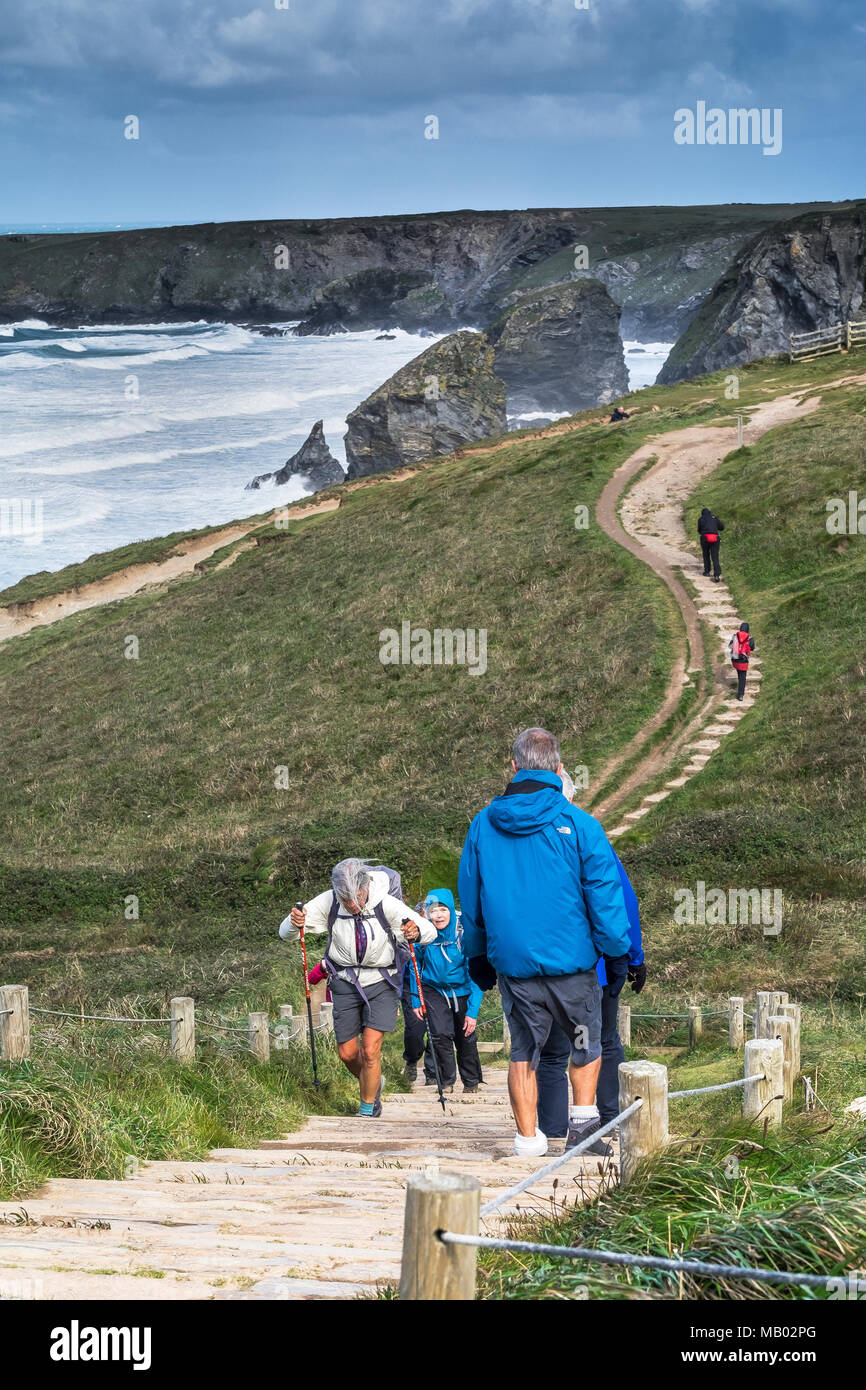 Walkers climbing up steep steps on the South West Coast Path at ...
