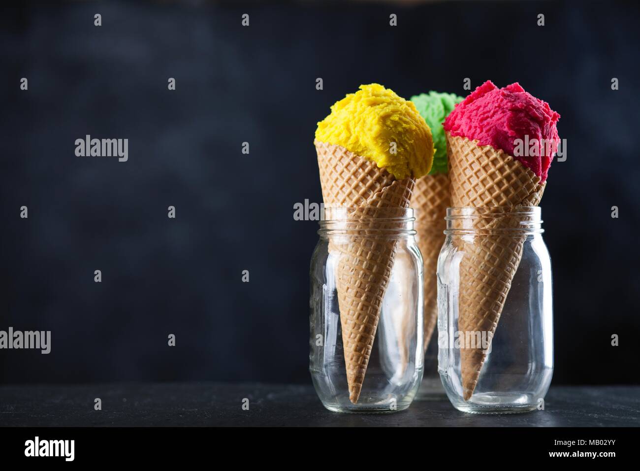 Ice cream cone on grey background Stock Photo - Alamy