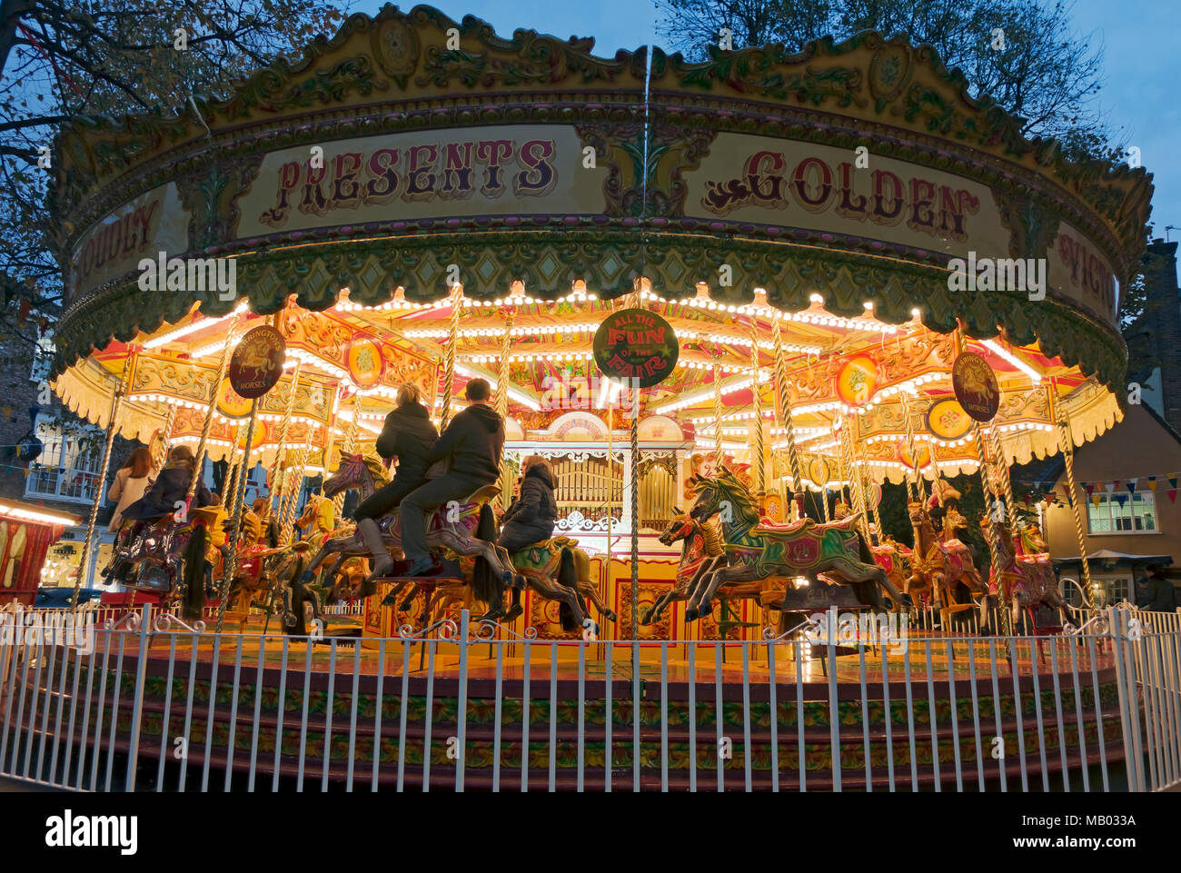 People on merry go round Stock Photo - Alamy