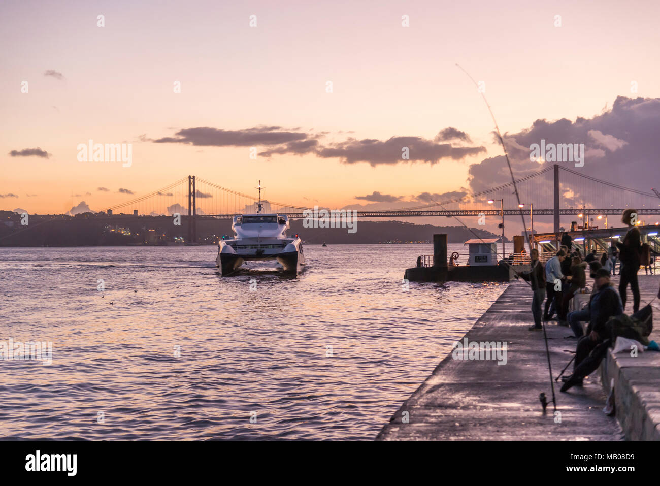 Evening atmosphere by the harbour in Lisbon Stock Photo - Alamy