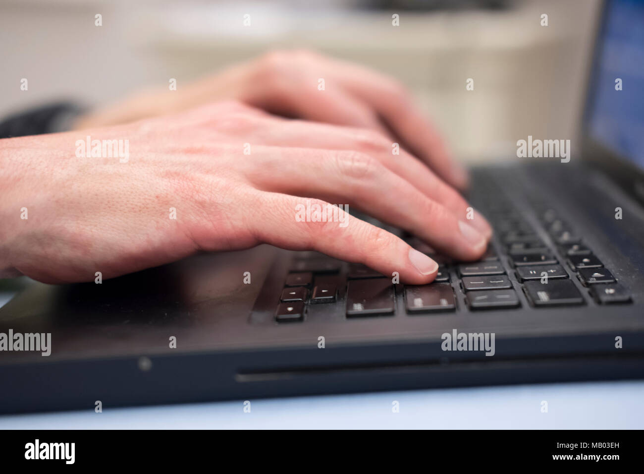 Typing on a laptop keyboard Stock Photo - Alamy