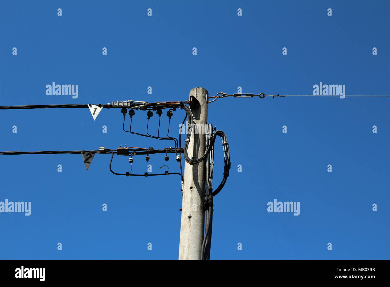 Concrete electrical power line utility pole with multiple numbered ...