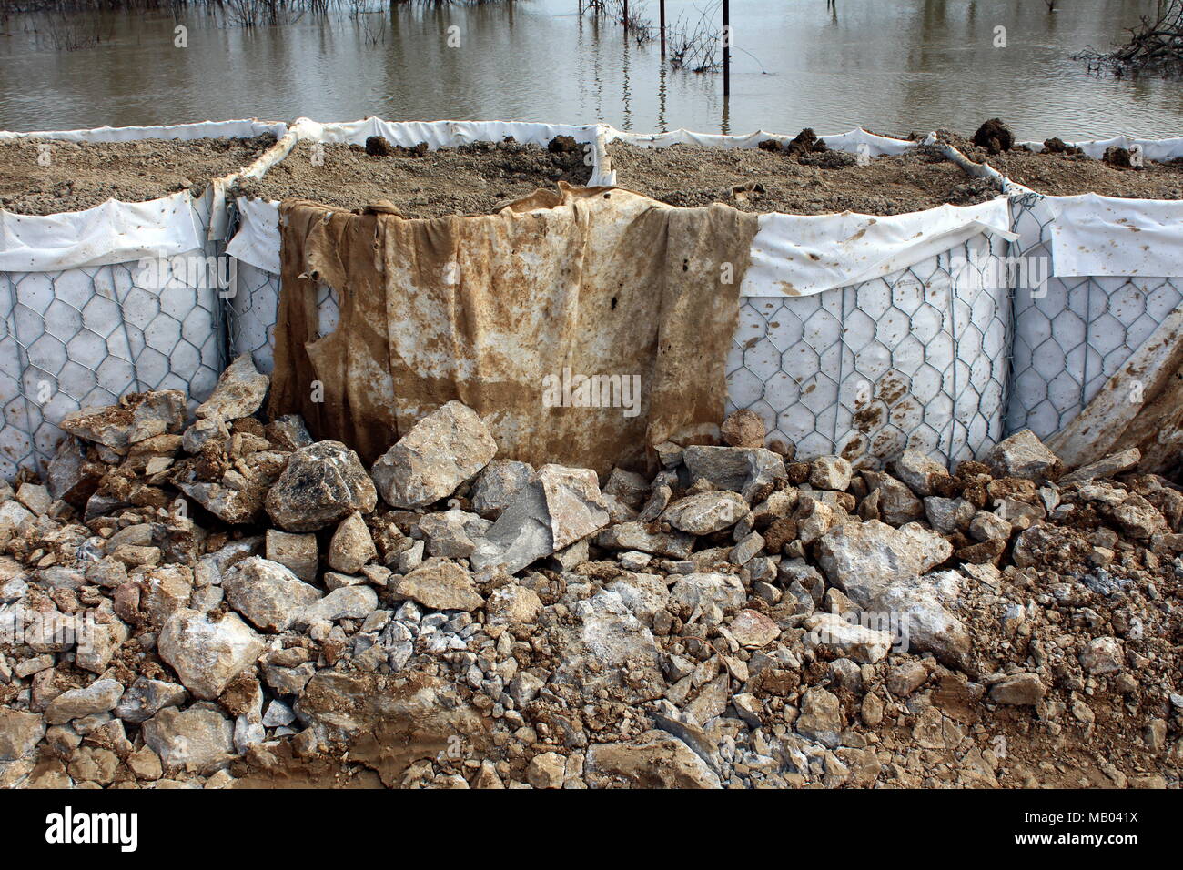 Sandbox barriers flood protection with broken geotextile fabric ...