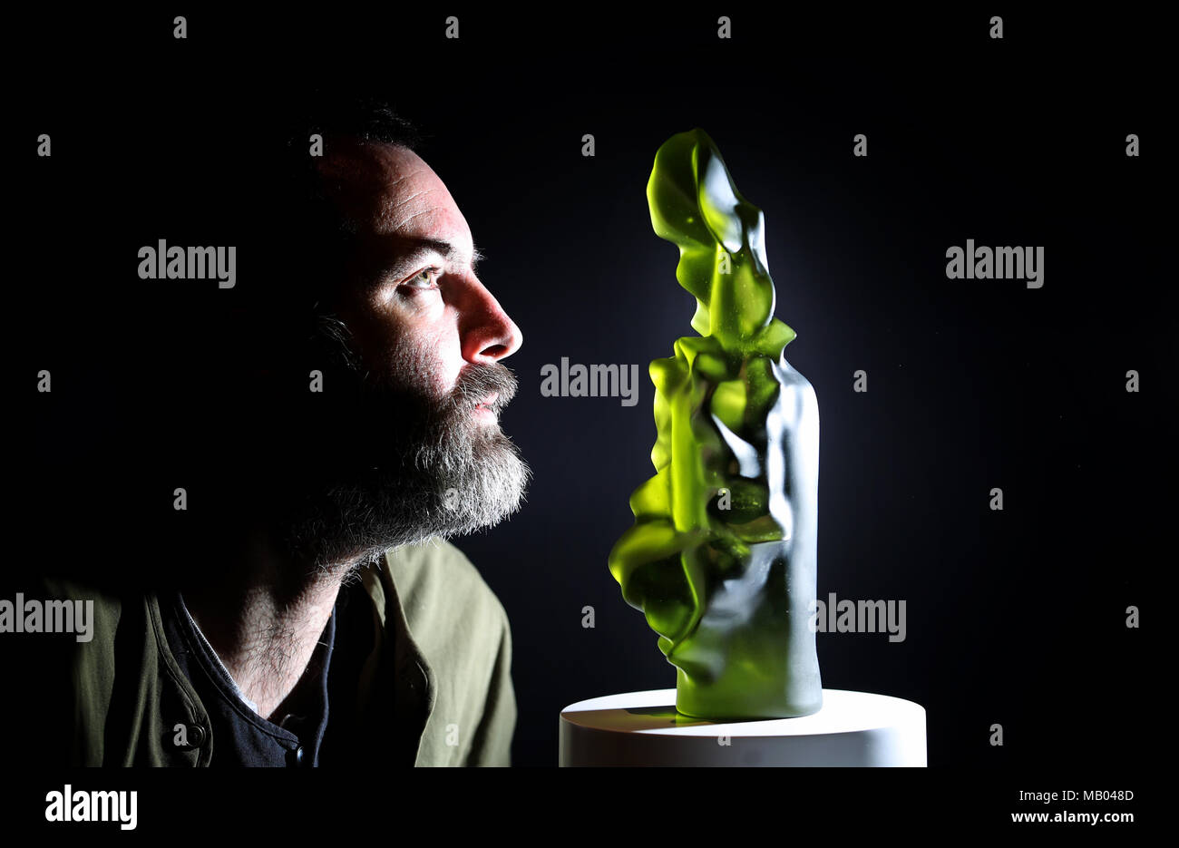 Artist Geoffrey Mann alongside his cast glass sculpture titled The ...