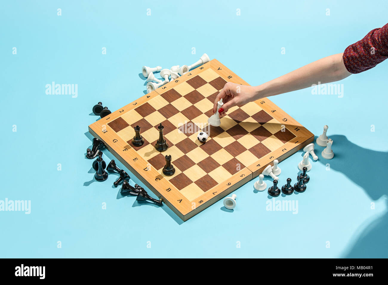 soccer ball of chess pieces on the board Stock Photo - Alamy