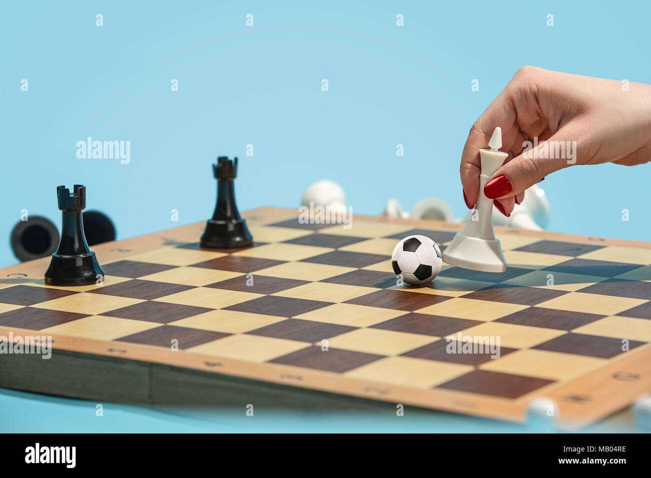 soccer ball of chess pieces on the board Stock Photo - Alamy