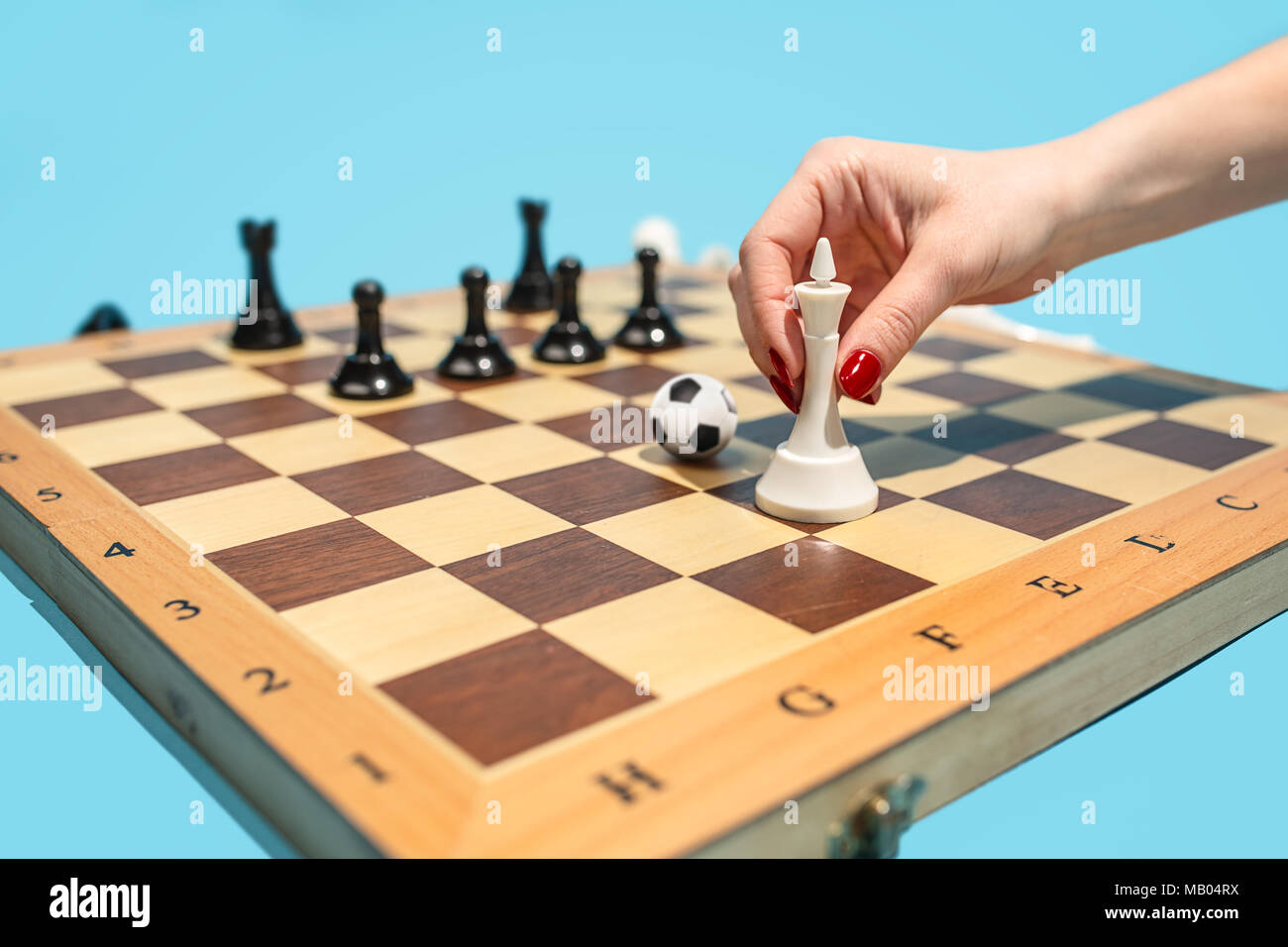 soccer ball of chess pieces on the board Stock Photo - Alamy