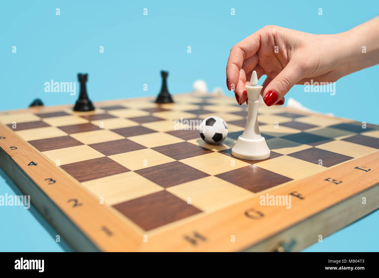 soccer ball of chess pieces on the board Stock Photo - Alamy
