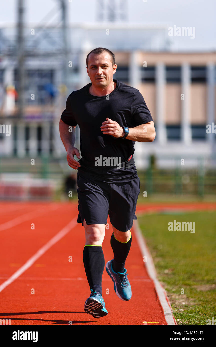 Male sprinter in middle age trains for race competition Stock Photo - Alamy