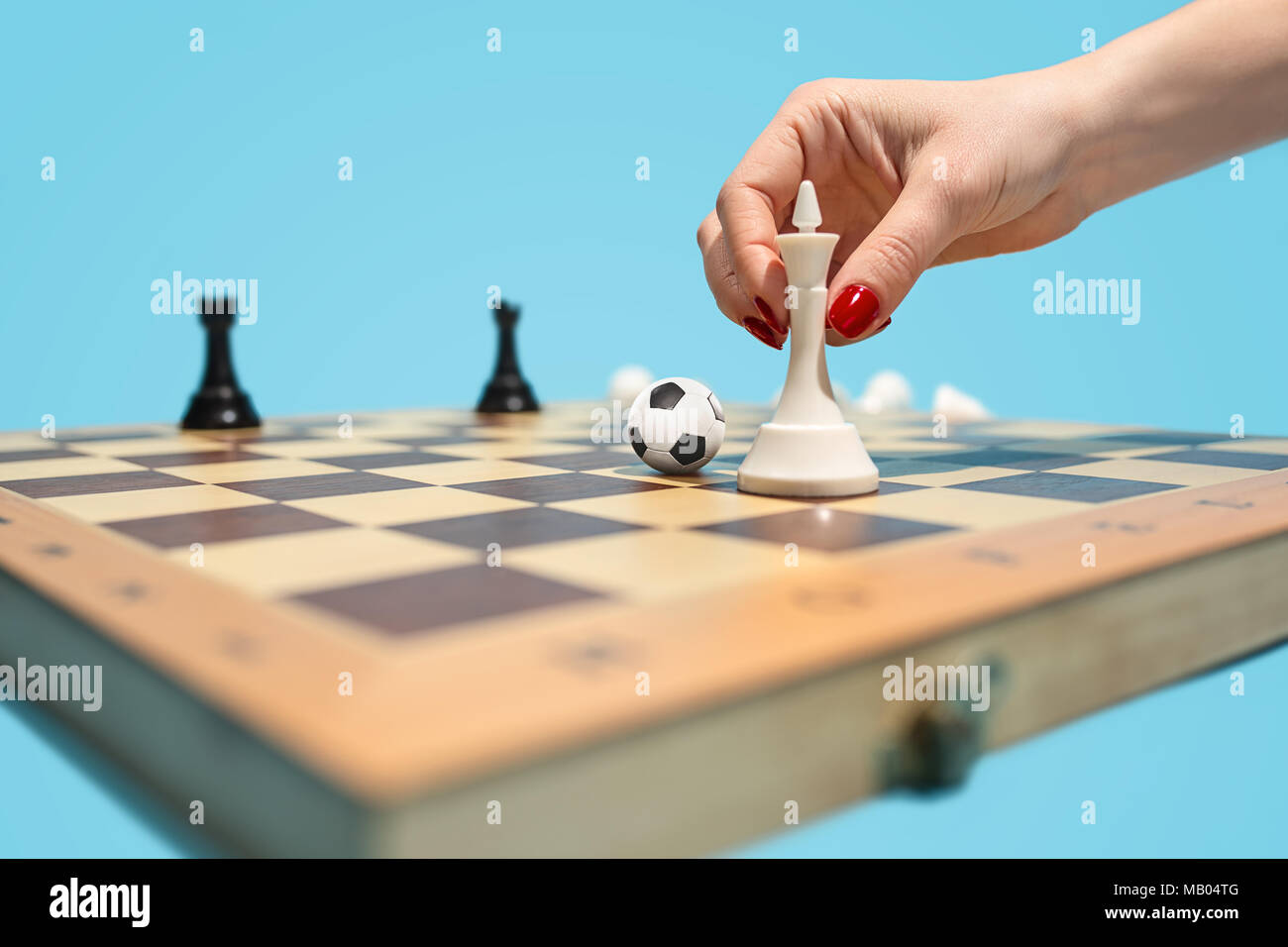 soccer ball of chess pieces on the board Stock Photo - Alamy