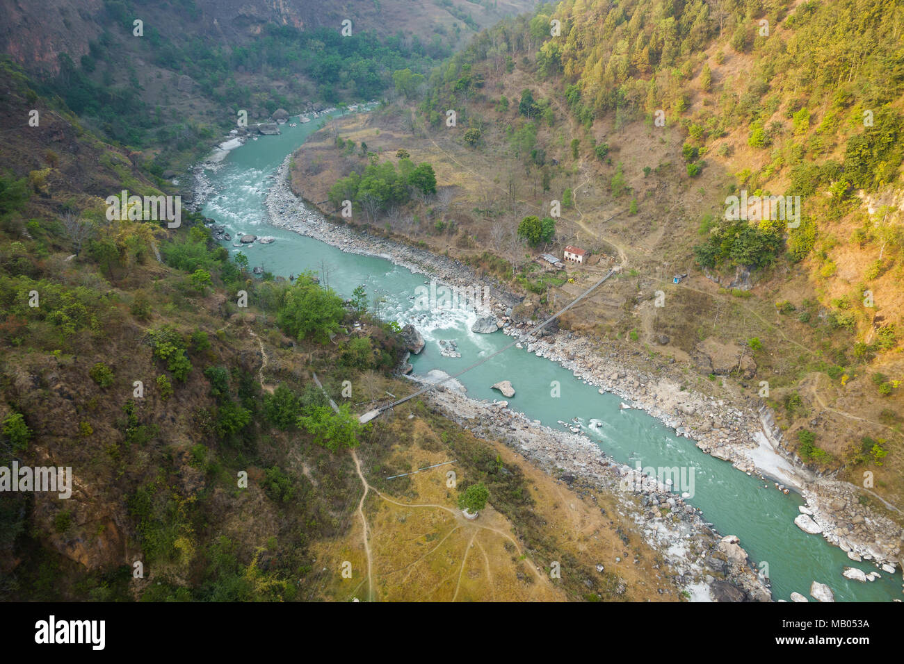 Aerial view of small suspension bridge over the Kali Gandaki river ...