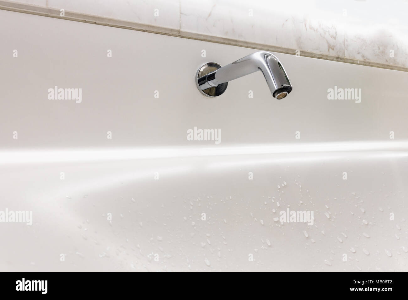 Modern faucet and hands washing sink in restroom Stock Photo - Alamy