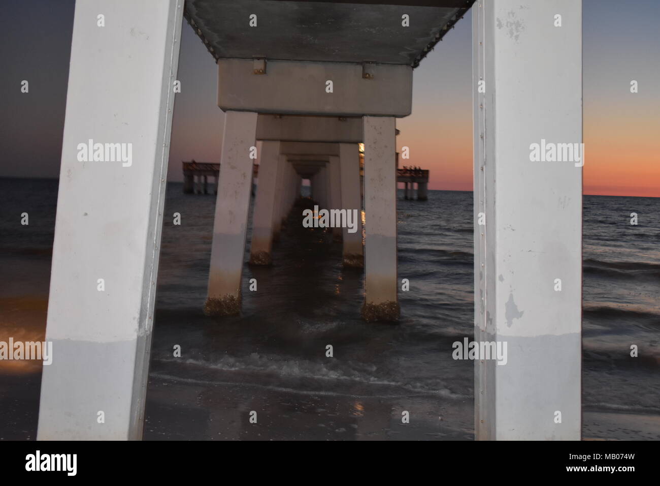 Underside of coastal pier at sunset hi-res stock photography and images ...