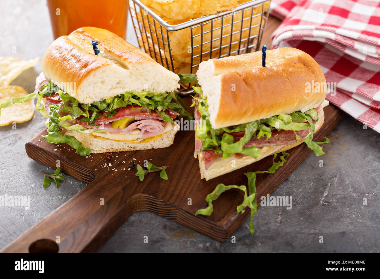 Italian sub sandwich with salami, ham and chips Stock Photo - Alamy