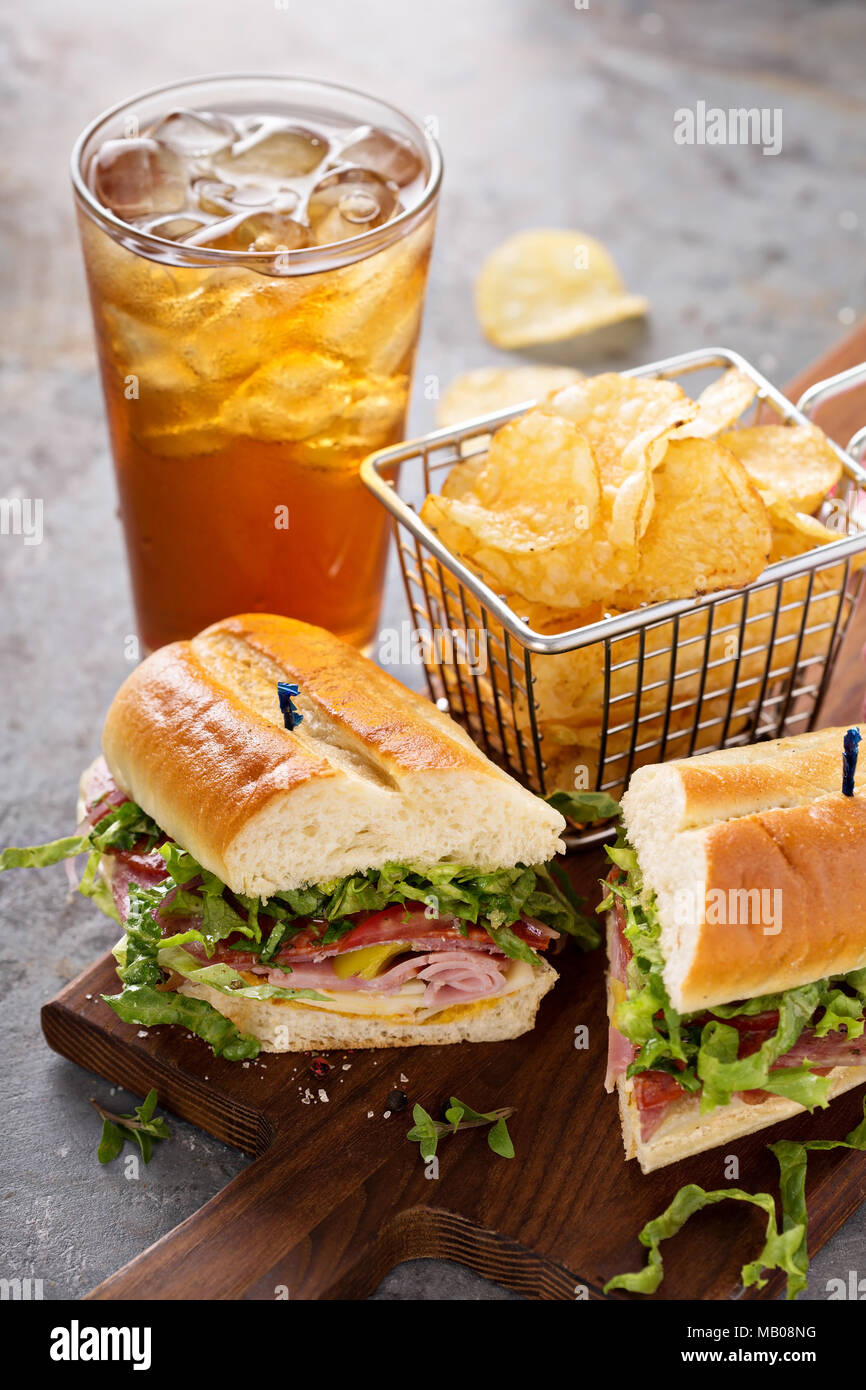 Italian sub sandwich with salami, ham and chips Stock Photo - Alamy
