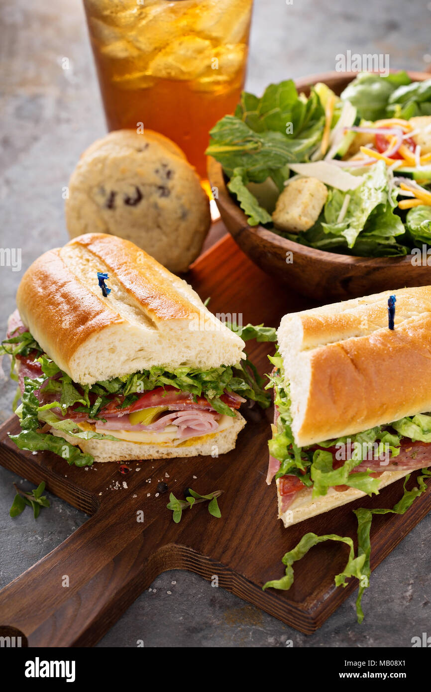 Italian sub sandwich with salami, ham and caesar salad Stock Photo - Alamy