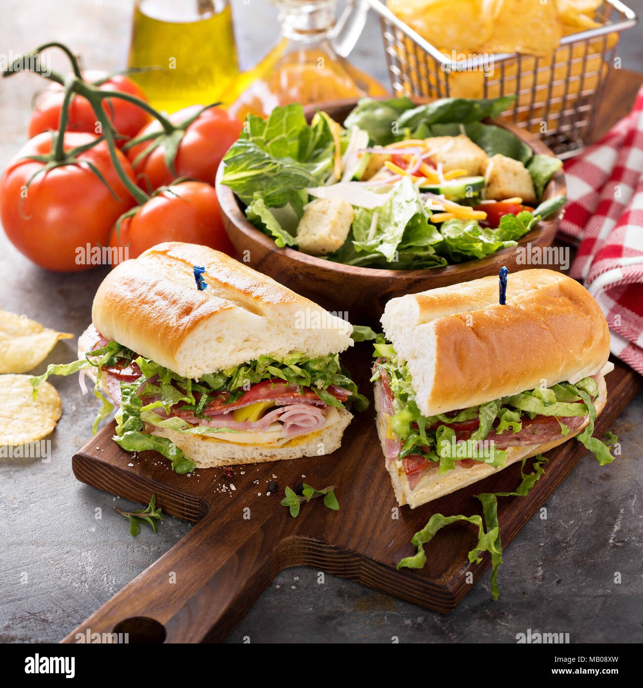 Italian sub sandwich with salami, ham and caesar salad Stock Photo - Alamy