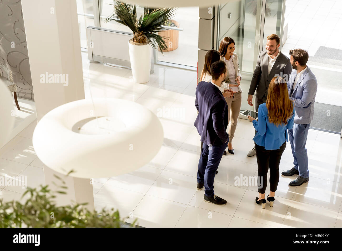 Overhead view of people having business meeting Stock Photo - Alamy