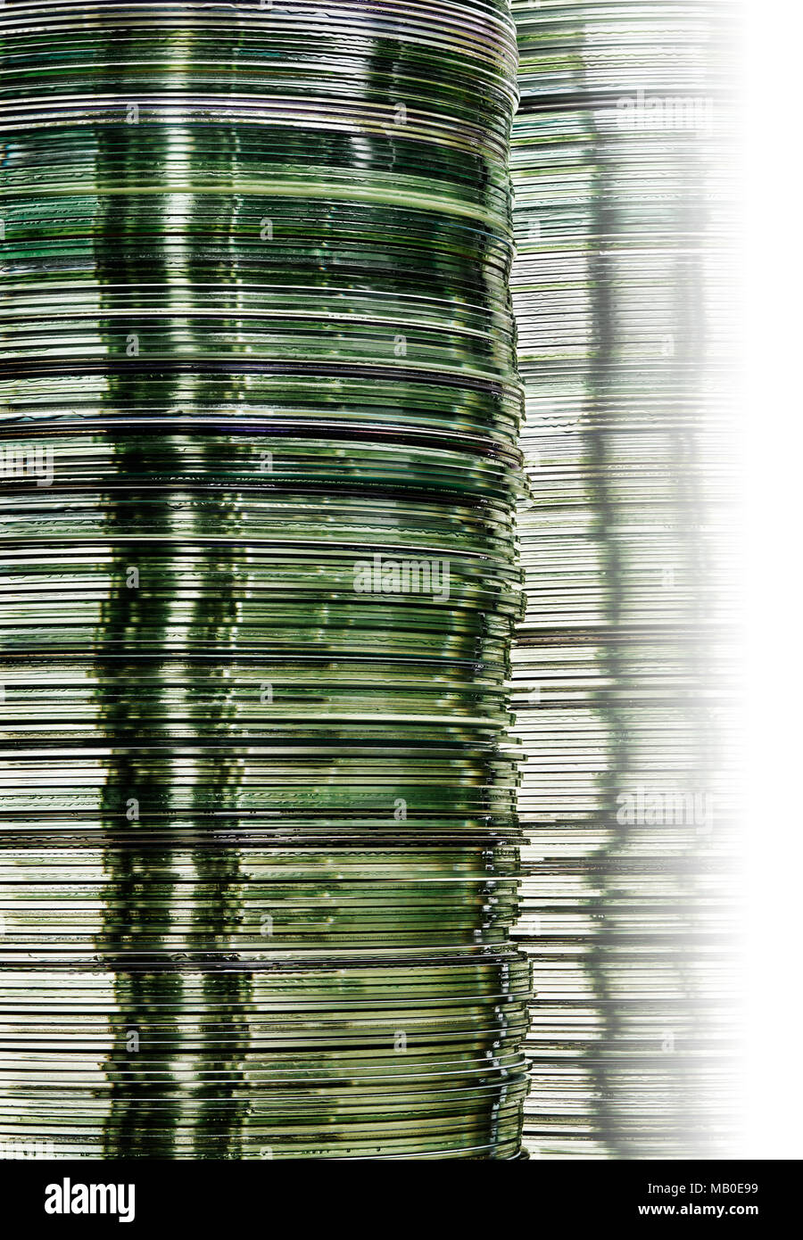 Stacks of monochrome metallic DVD and CD computer storage disks create ...