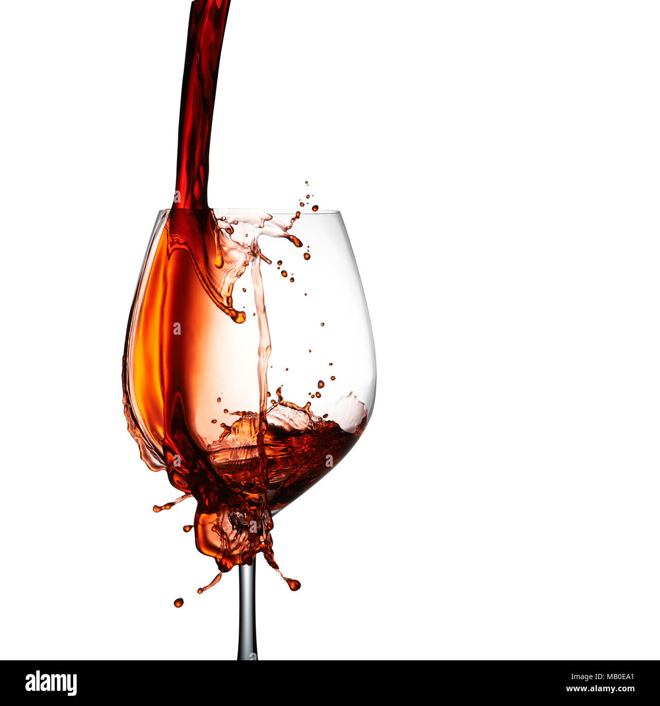 Graphic stop action capture of red wine splashing on to simple elegant ...