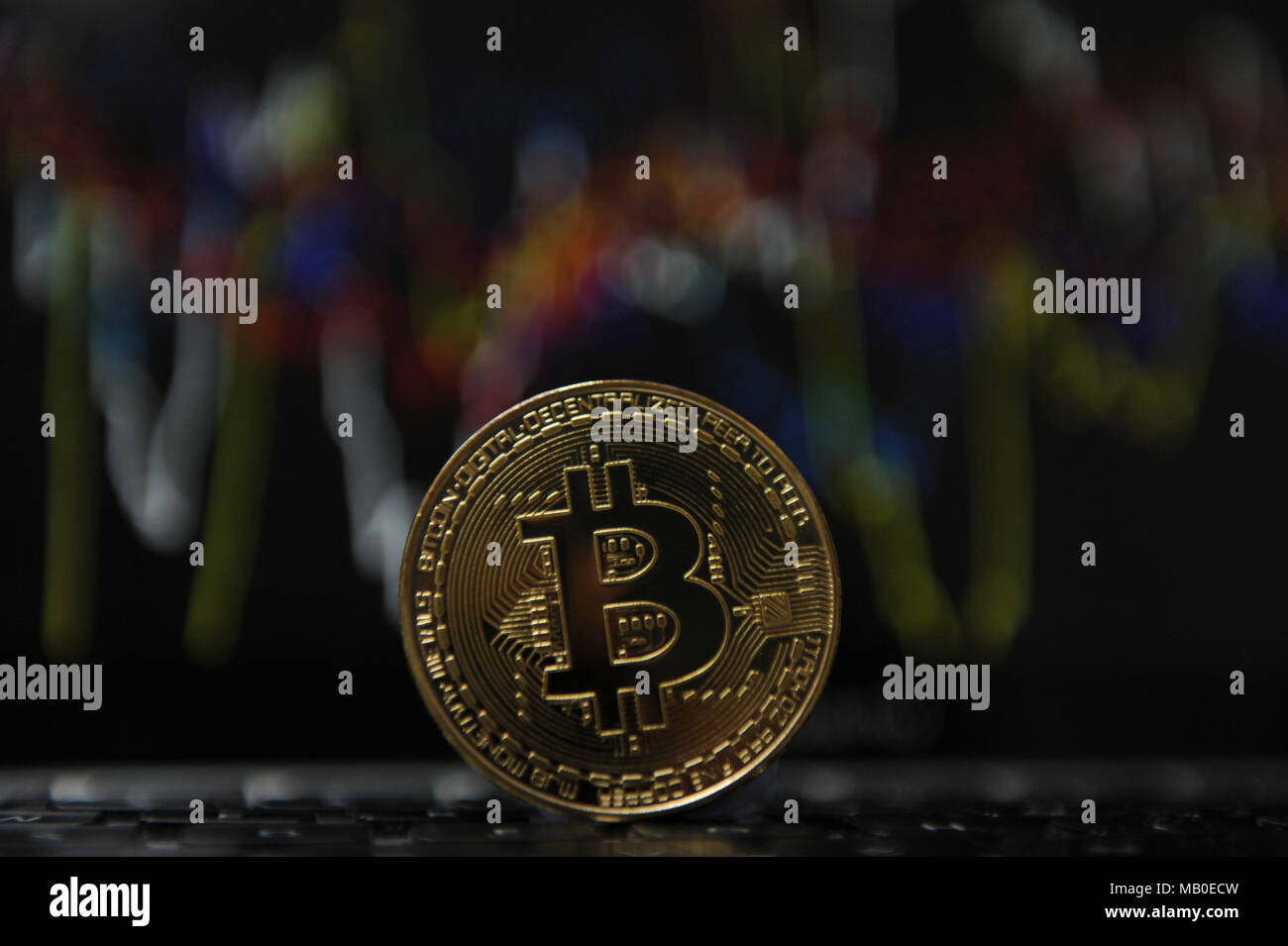 Bitcoin infront of a stock market graph Stock Photo - Alamy