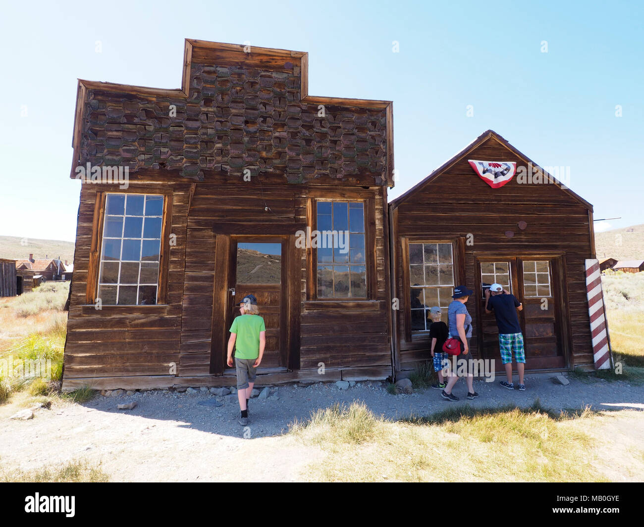 Bodie, CA (USA) - 10 August 2016: Tourists are peeking inside abandoned ...